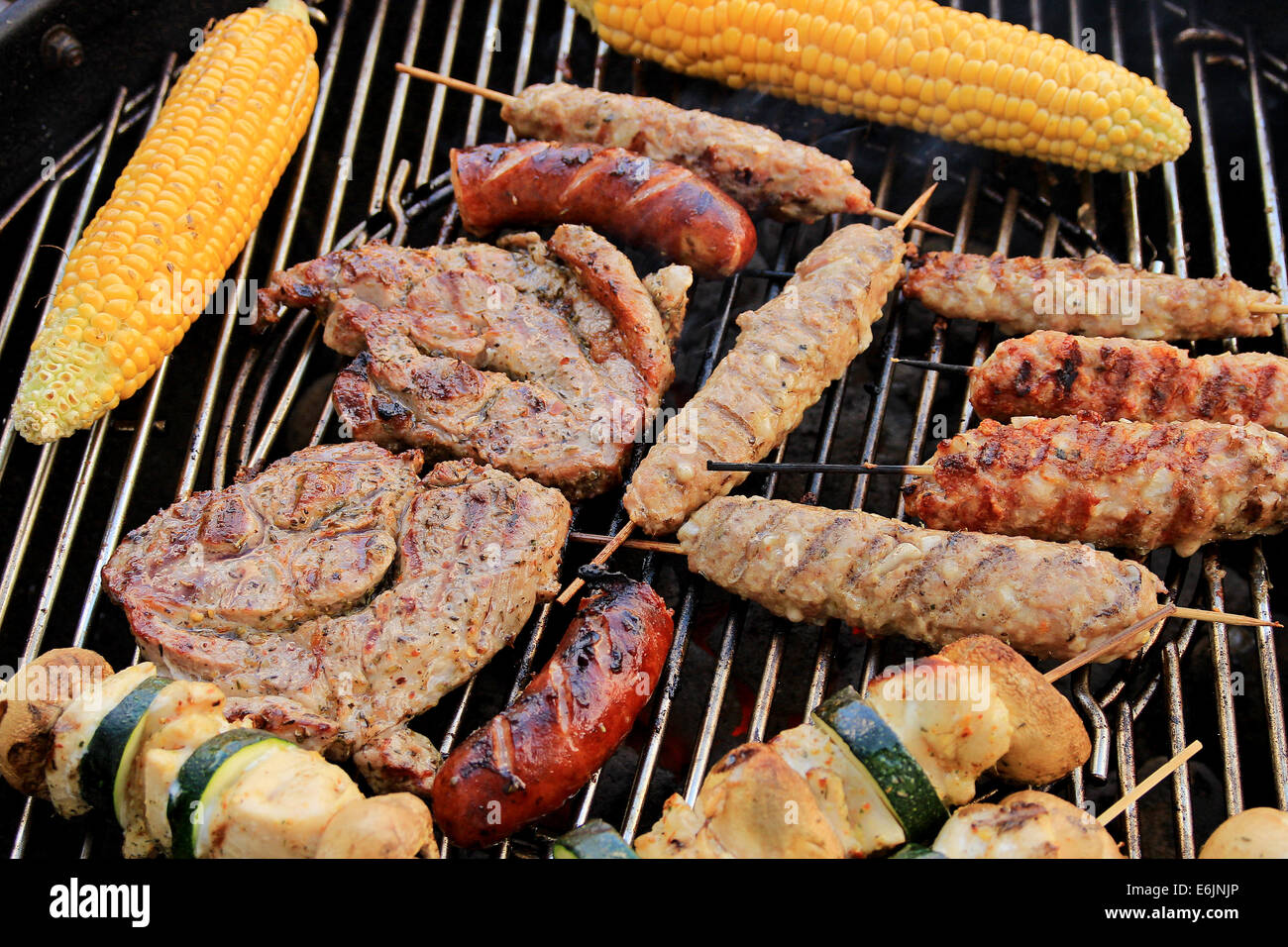 Cooking on a barbecue grill Stock Photo - Alamy
