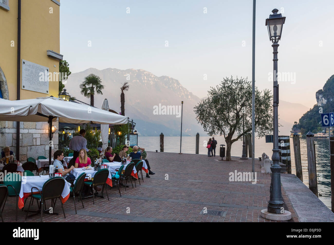 Restaurant on the harbourfront at sunset in the old town, Riva del ...