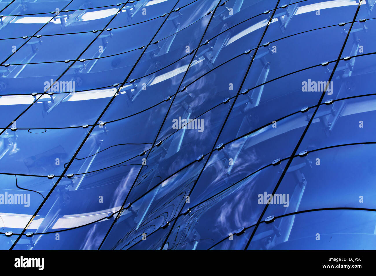 Wavy reflection on glass of modern office building Stock Photo - Alamy