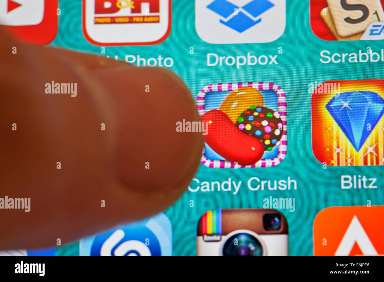 Selecting the Candy Crush ap on an iPhone Stock Photo - Alamy