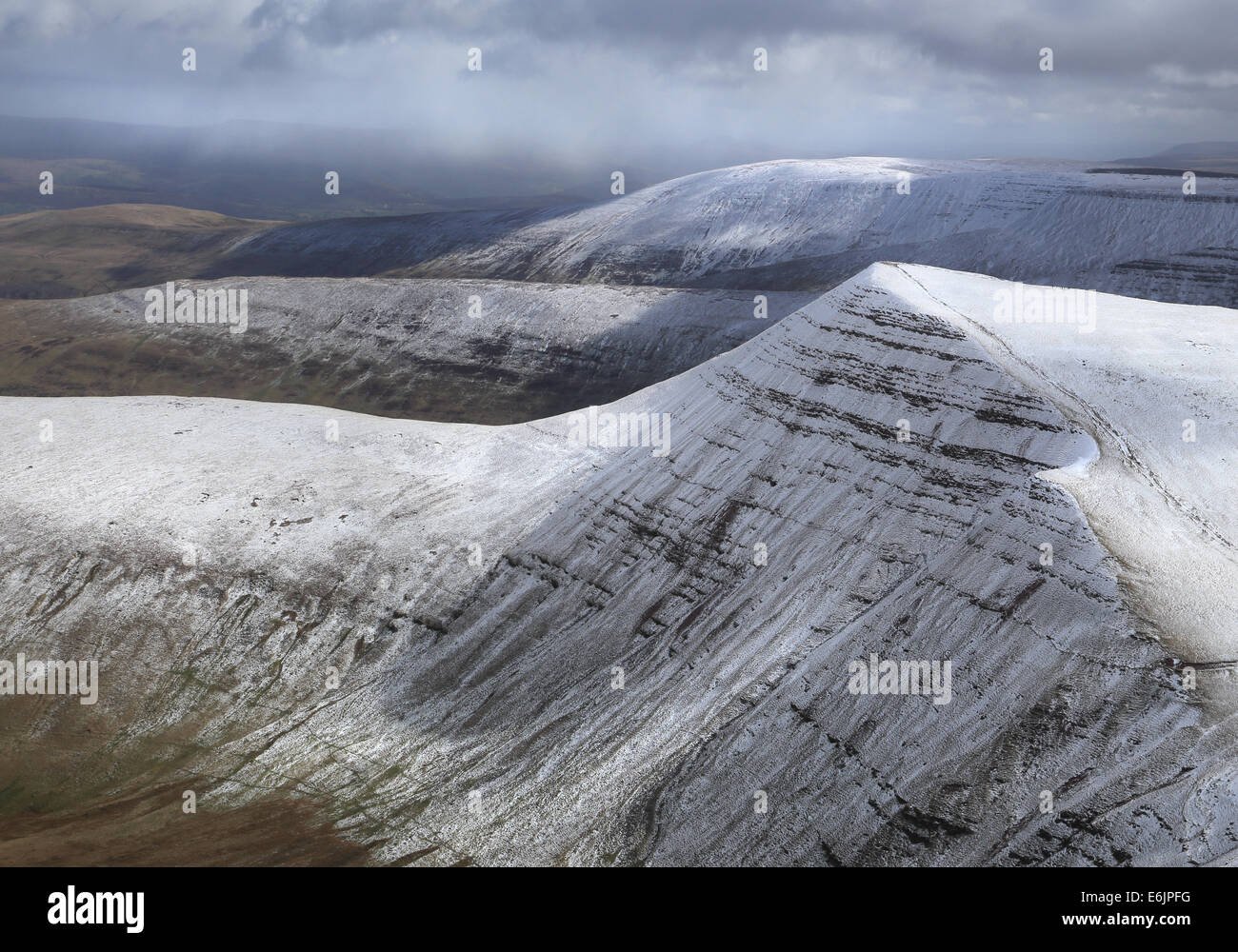 Passing storms, sun and snow on Brecon Beacons high peaks with stormy ...