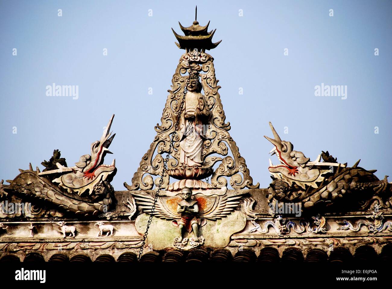 XINDU, CHINA: Double dragons and Buddha figure atop the center beam of ...