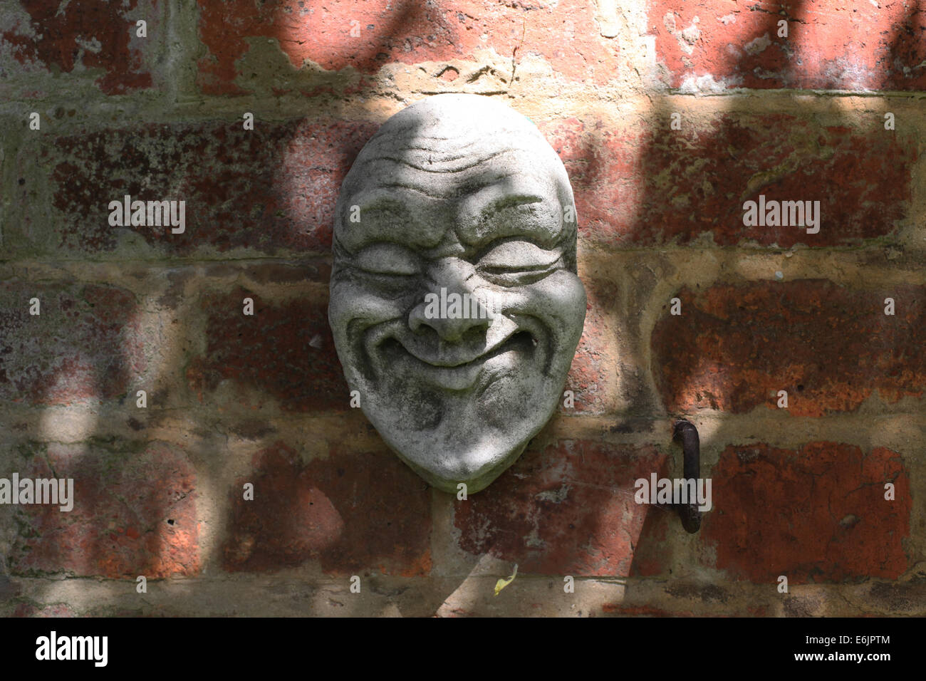 Face on brick wall hi-res stock photography and images - Alamy
