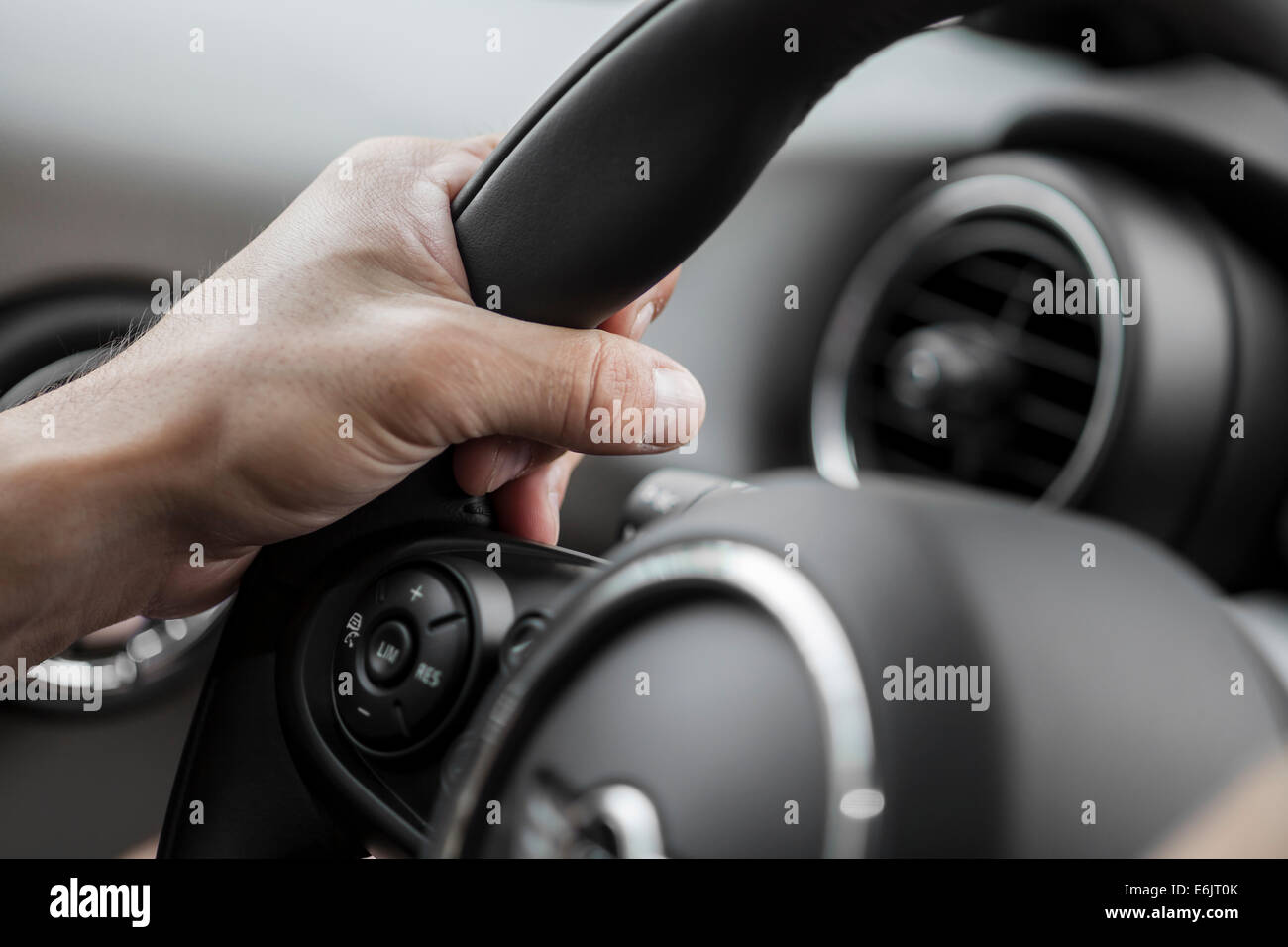 Detail of a hand holding a steering wheel Stock Photo - Alamy