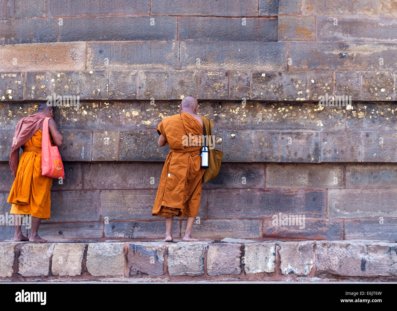 Two Buddhist monks talking to the Dhamekh Stupa, while leaning against ...