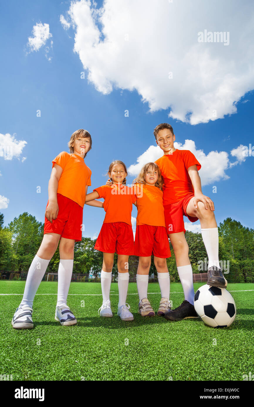 Happy kids of different height with football Stock Photo - Alamy