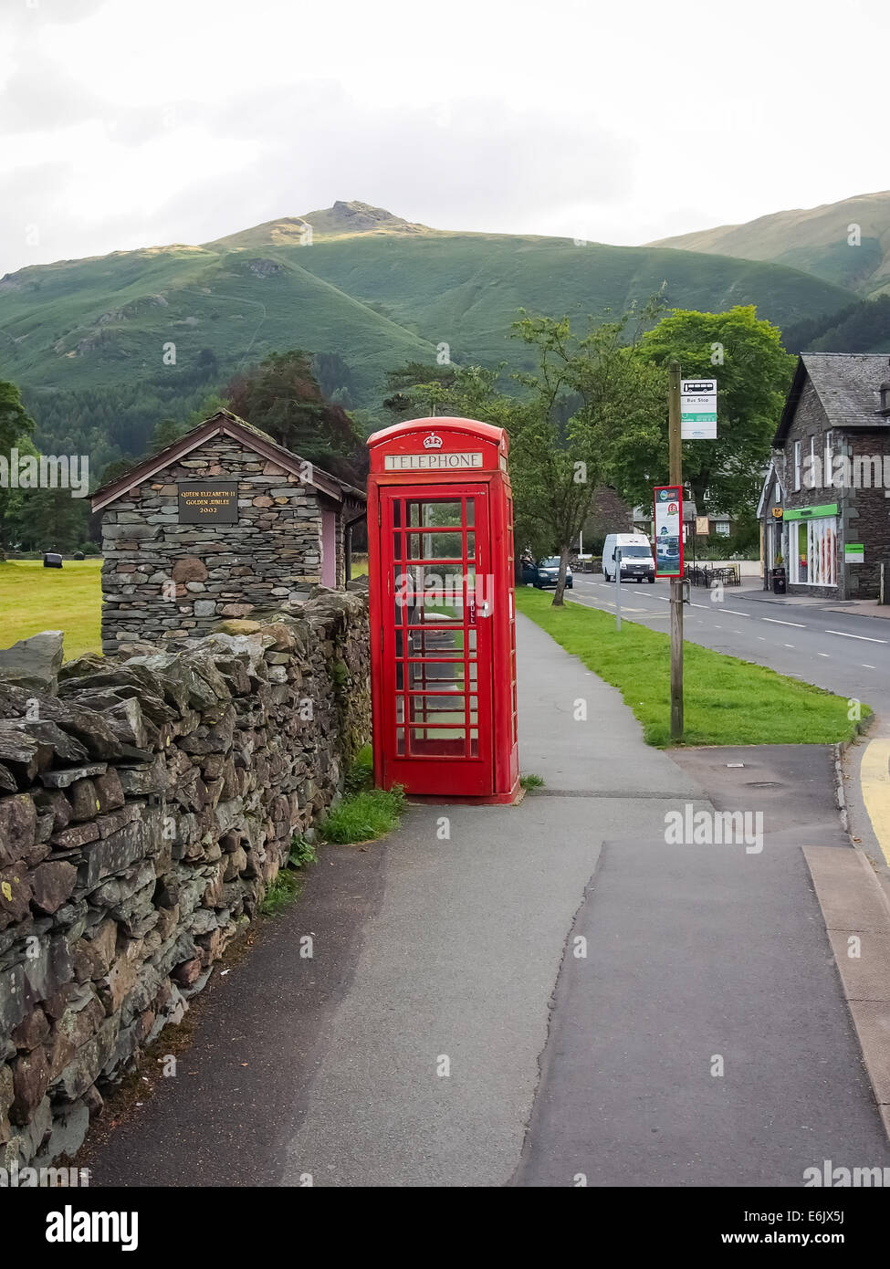 A red telephone box and bus stop in a British rural village Stock Photo ...
