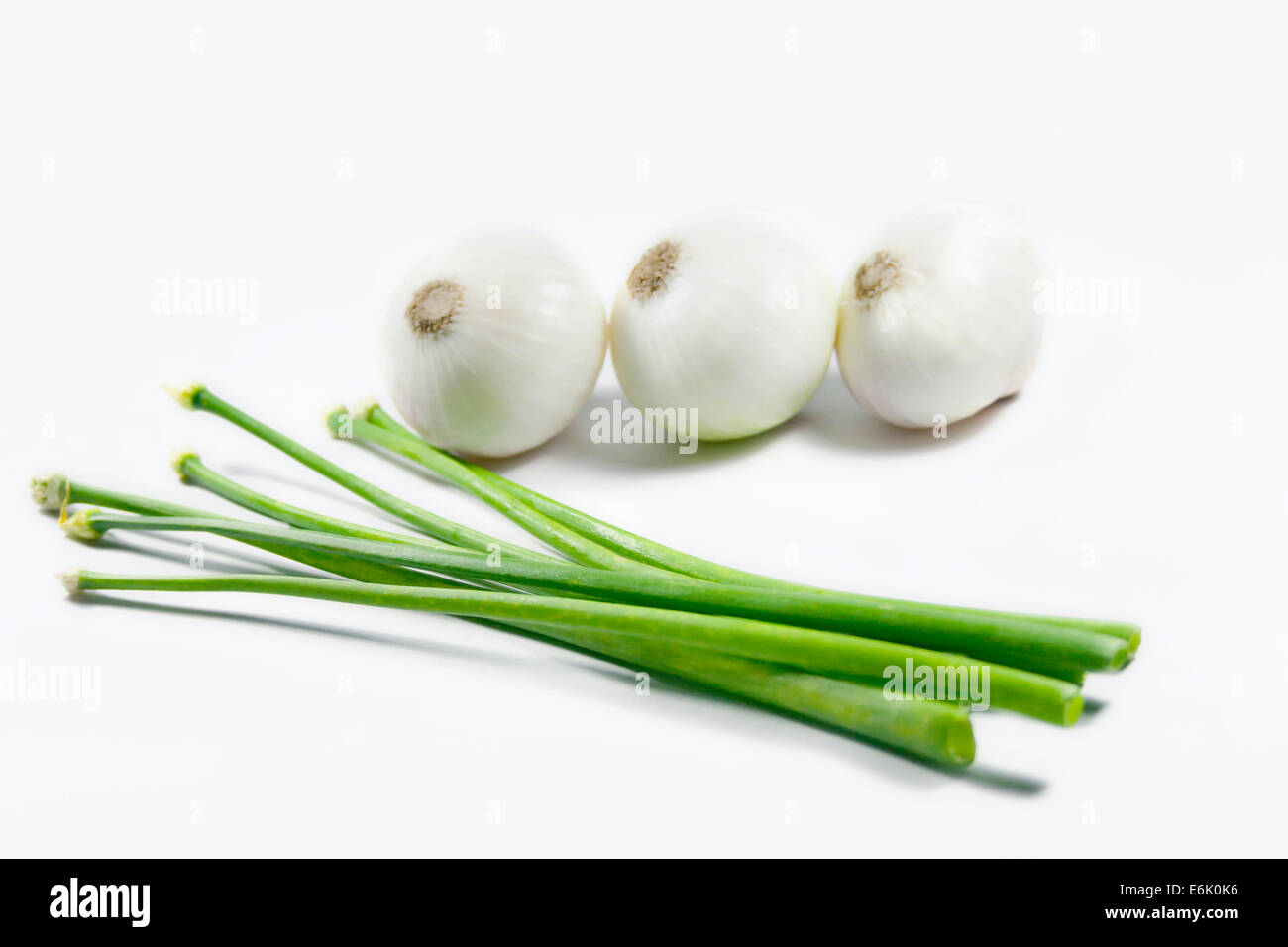 Three onions on a white background, with leave Stock Photo - Alamy