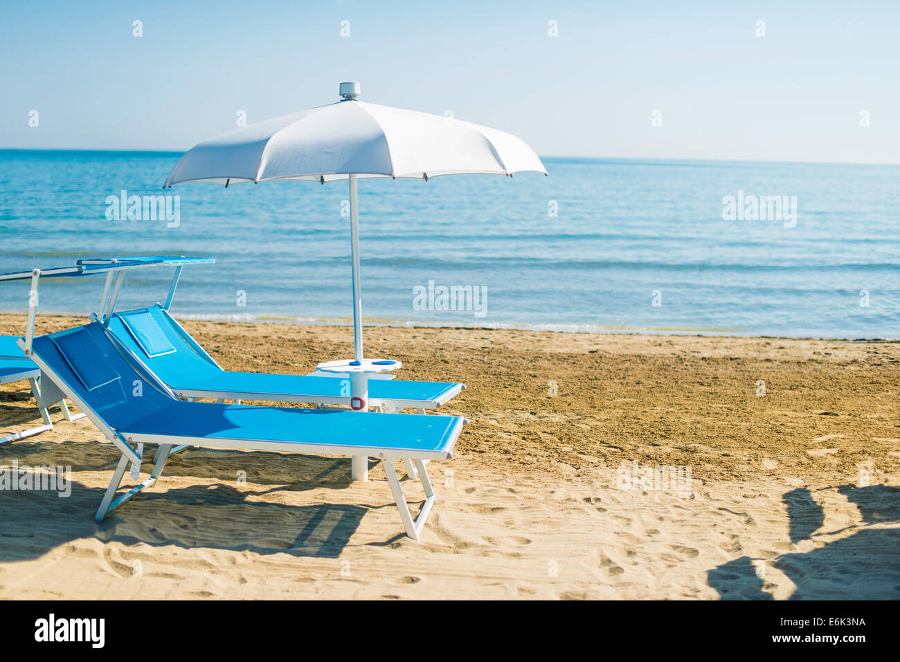 Blue sunbeds and umbrellas on the beach Stock Photo - Alamy