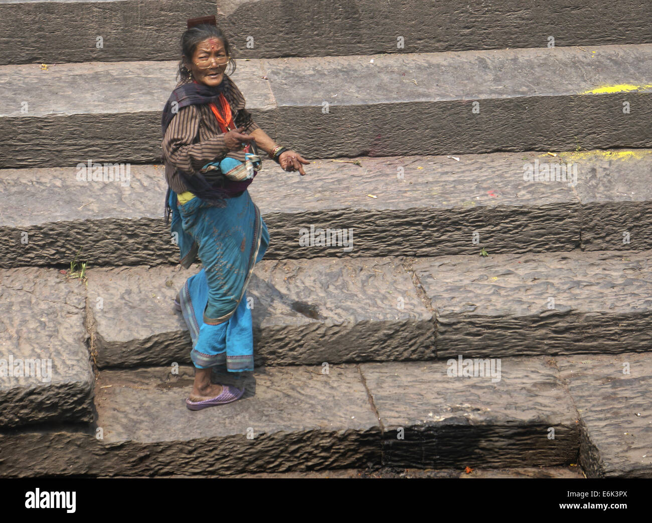 old lady descending stone stairs ,blue sari Stock Photo - Alamy