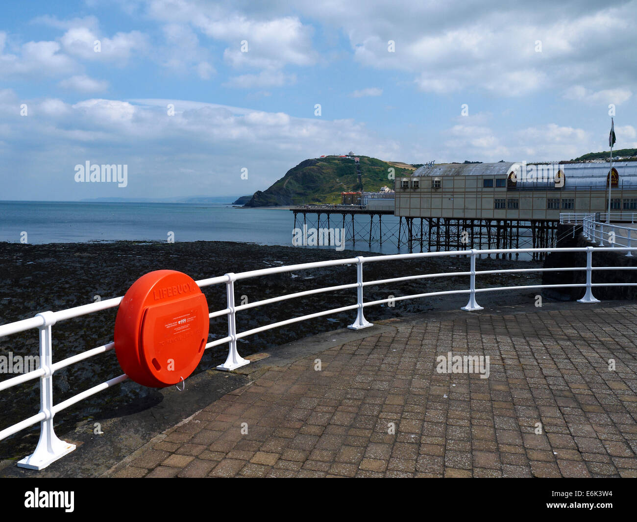 Lifebuoy on promenade with Royal Pier and constitution hill in ...