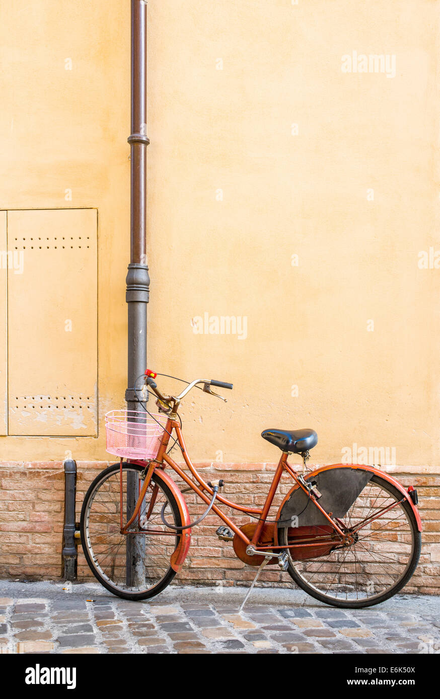 Red old Italian bicycle on sunlight. Ancient buildings Stock Photo - Alamy
