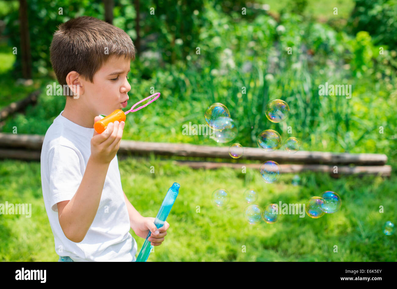 Child makes bubbles. Green park Stock Photo - Alamy