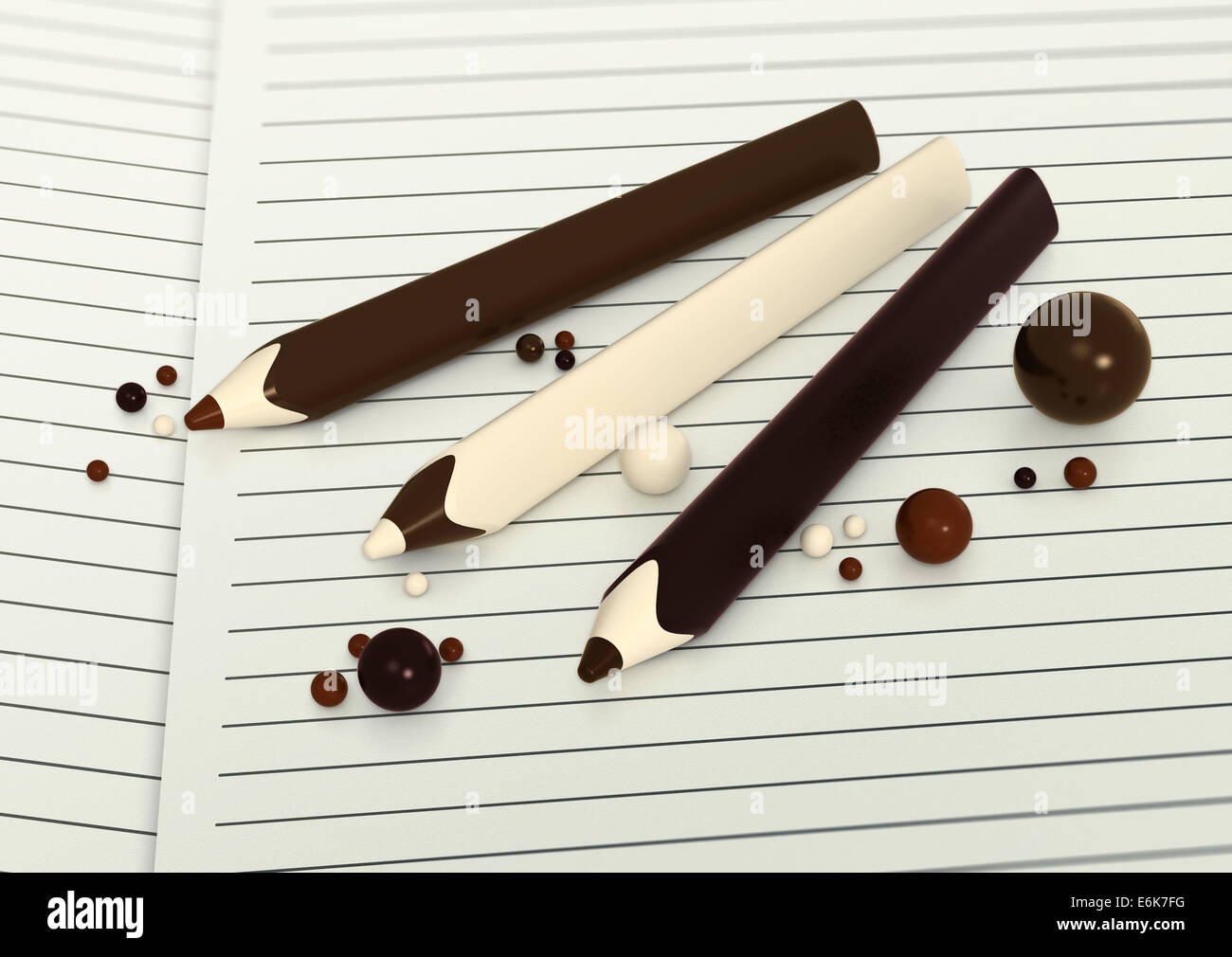 Different chocolate pencils and balls on line paper background for ...