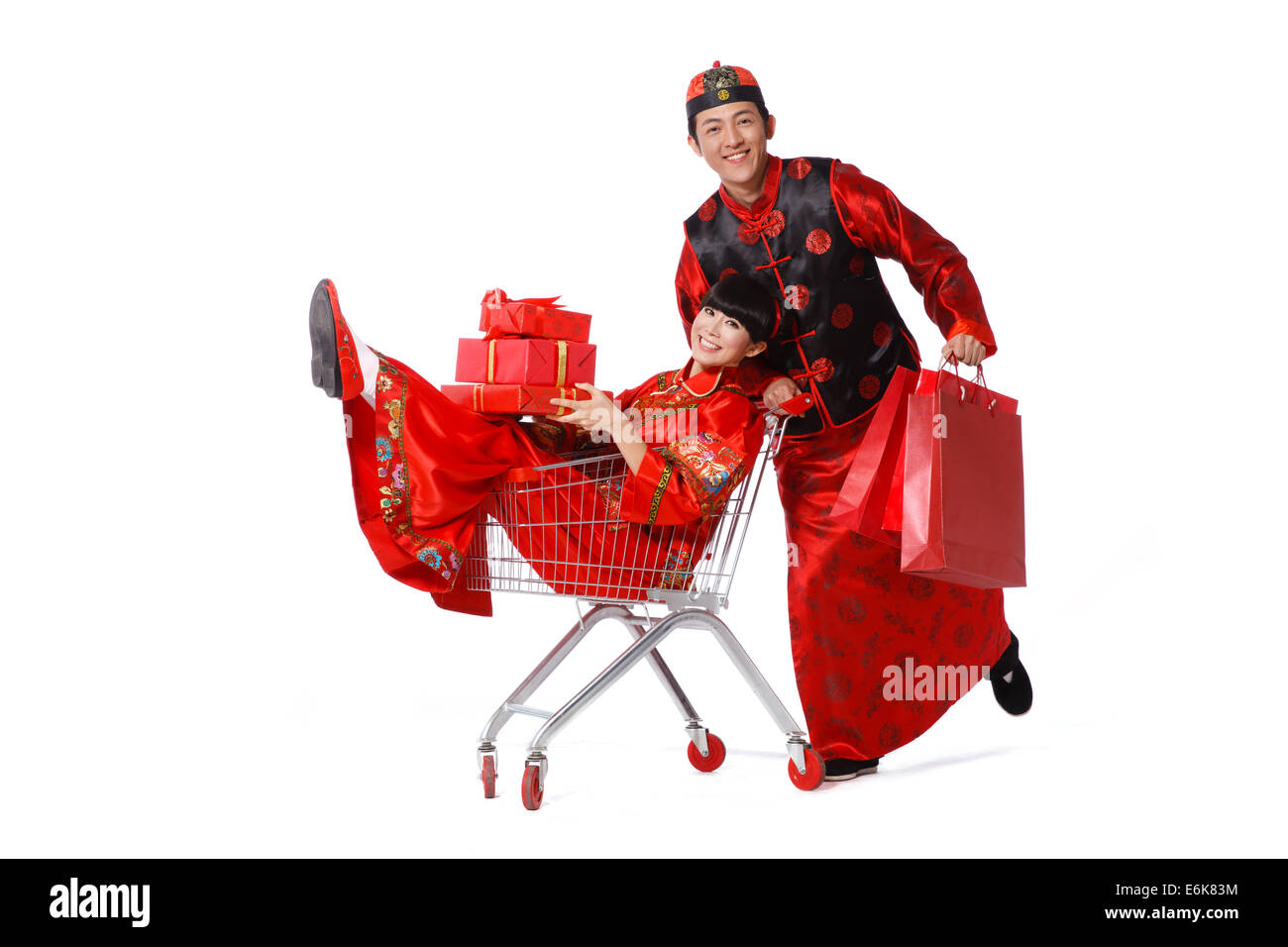 Young couple dressed in traditional clothes shopping with cart Stock ...