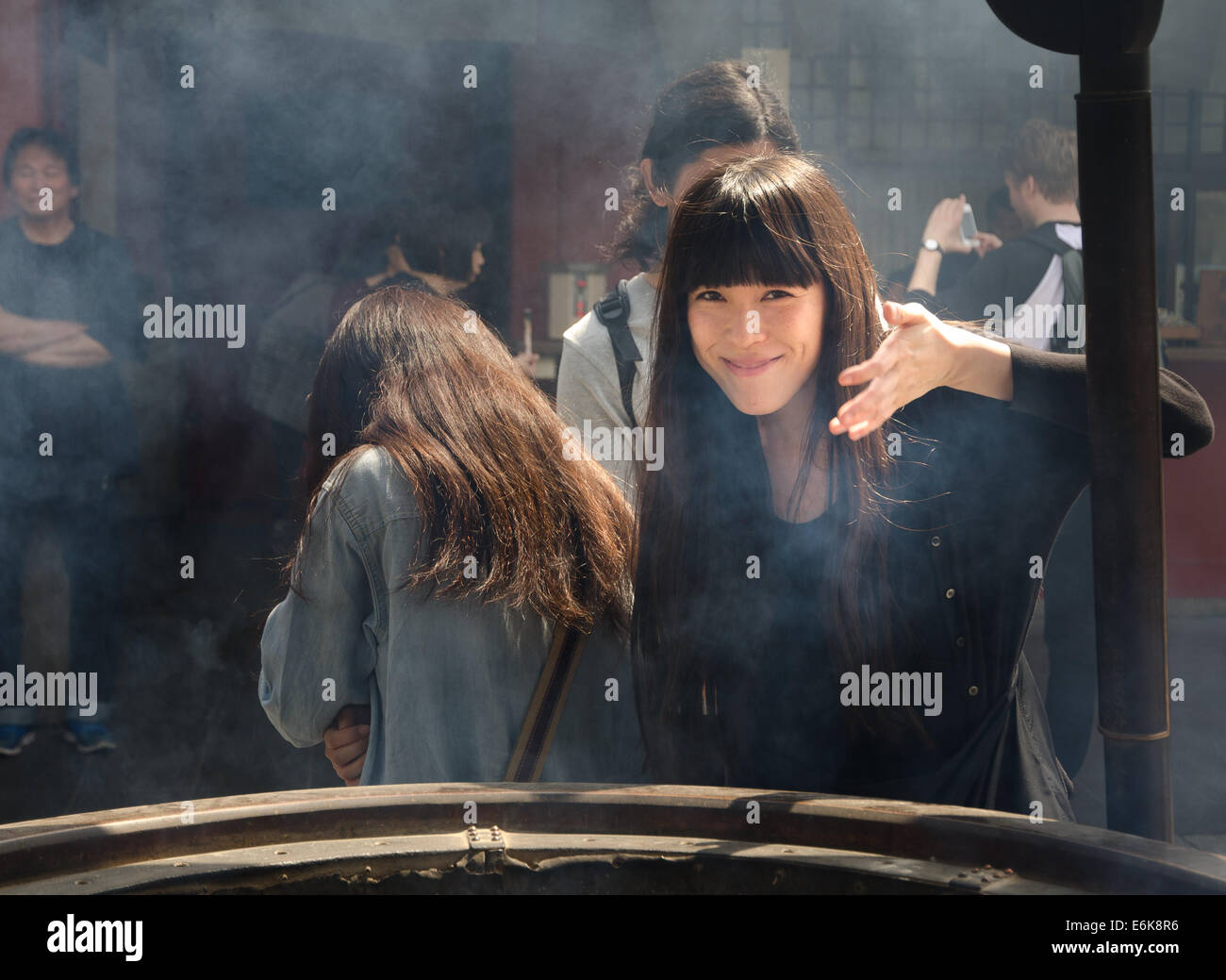 Japan girl having smoke in front of Senso-ji temple in Tokyo Asakusa ...