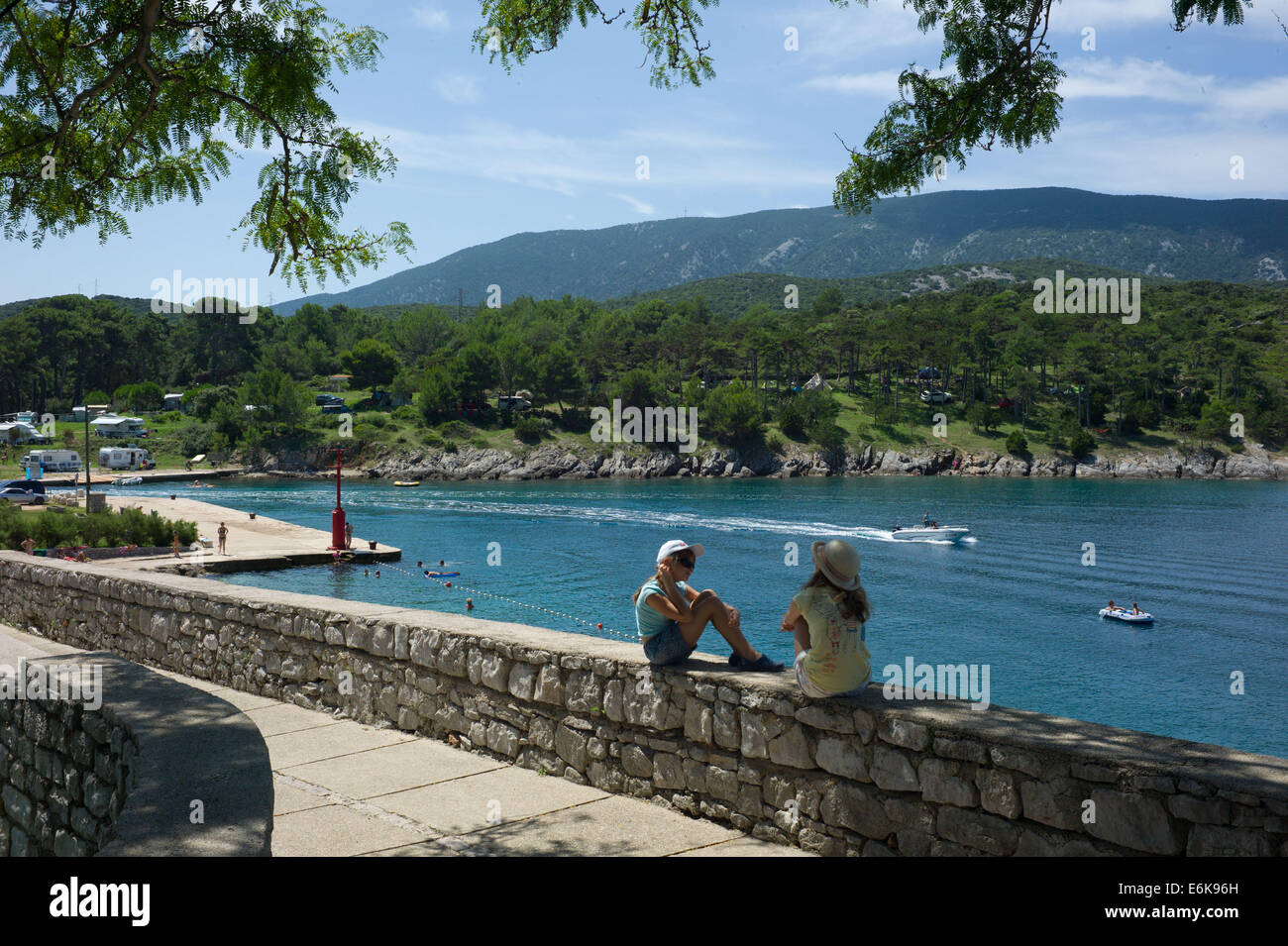children on seafront wall Osor village. Cres Island, Croatia Stock ...