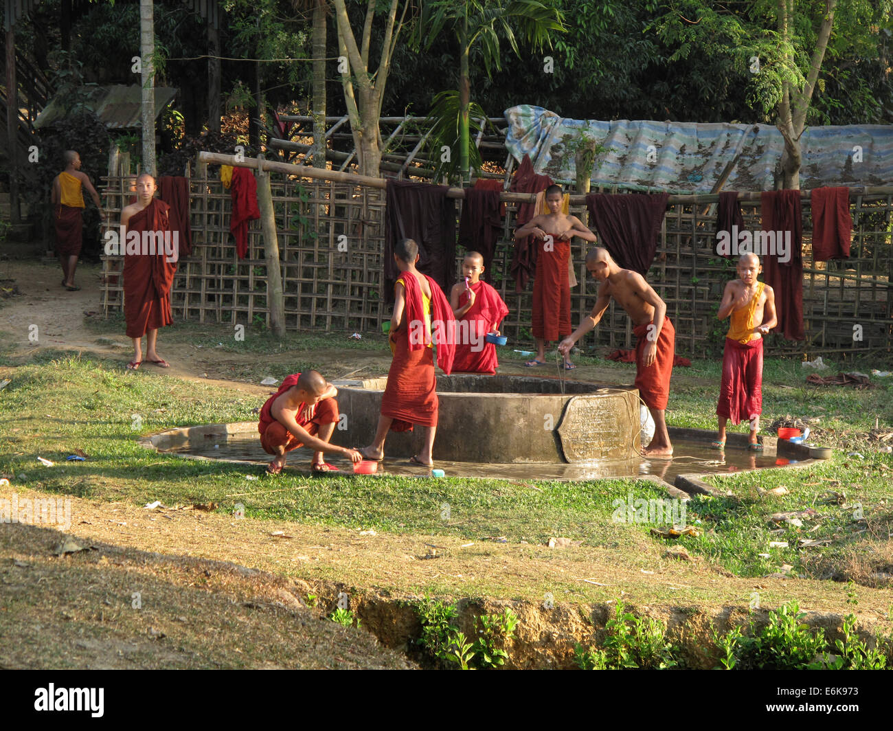 Young monks having their morning hygiene by old well Stock Photo - Alamy