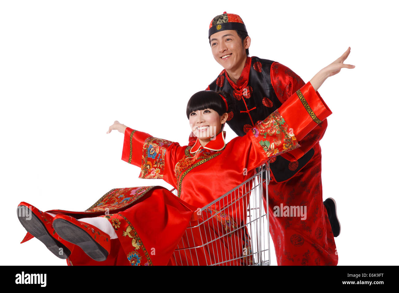 Young couple dressed in traditional clothes shopping with cart Stock ...
