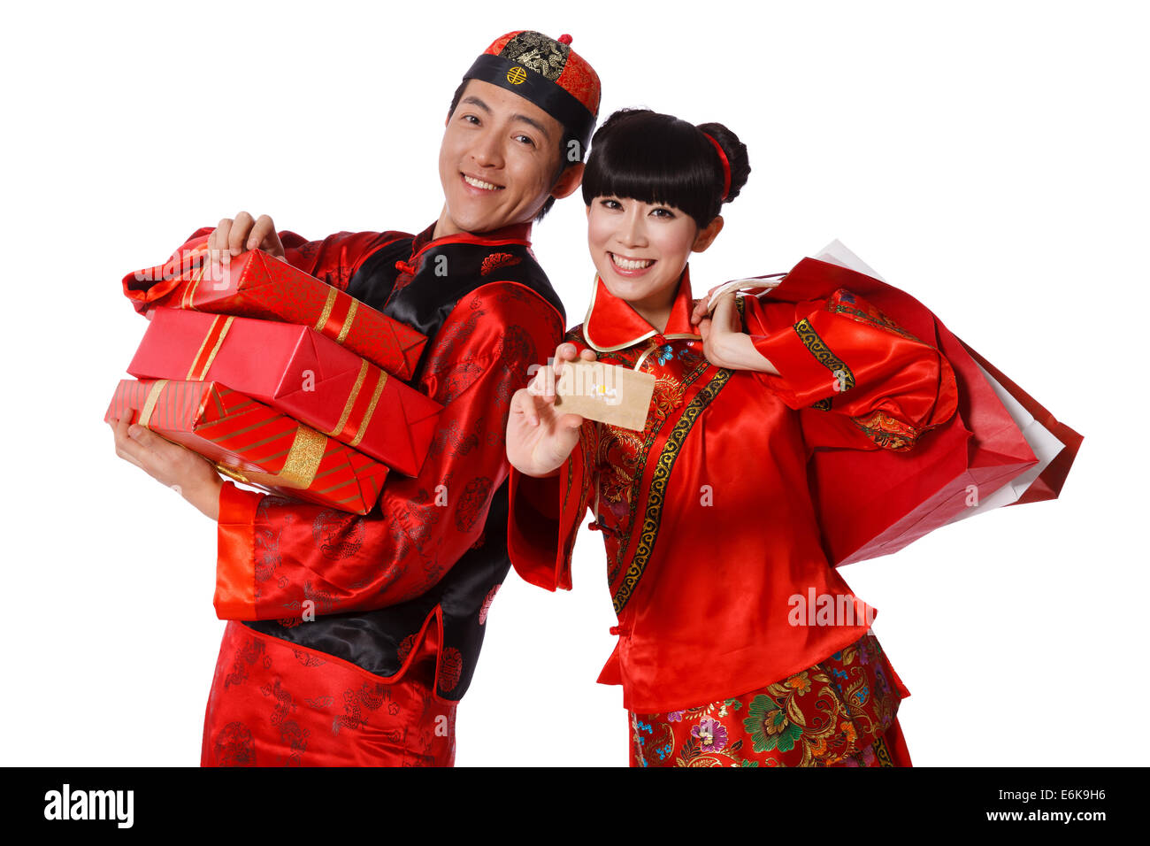 Young couple dressed in traditional clothes shopping with cart Stock ...