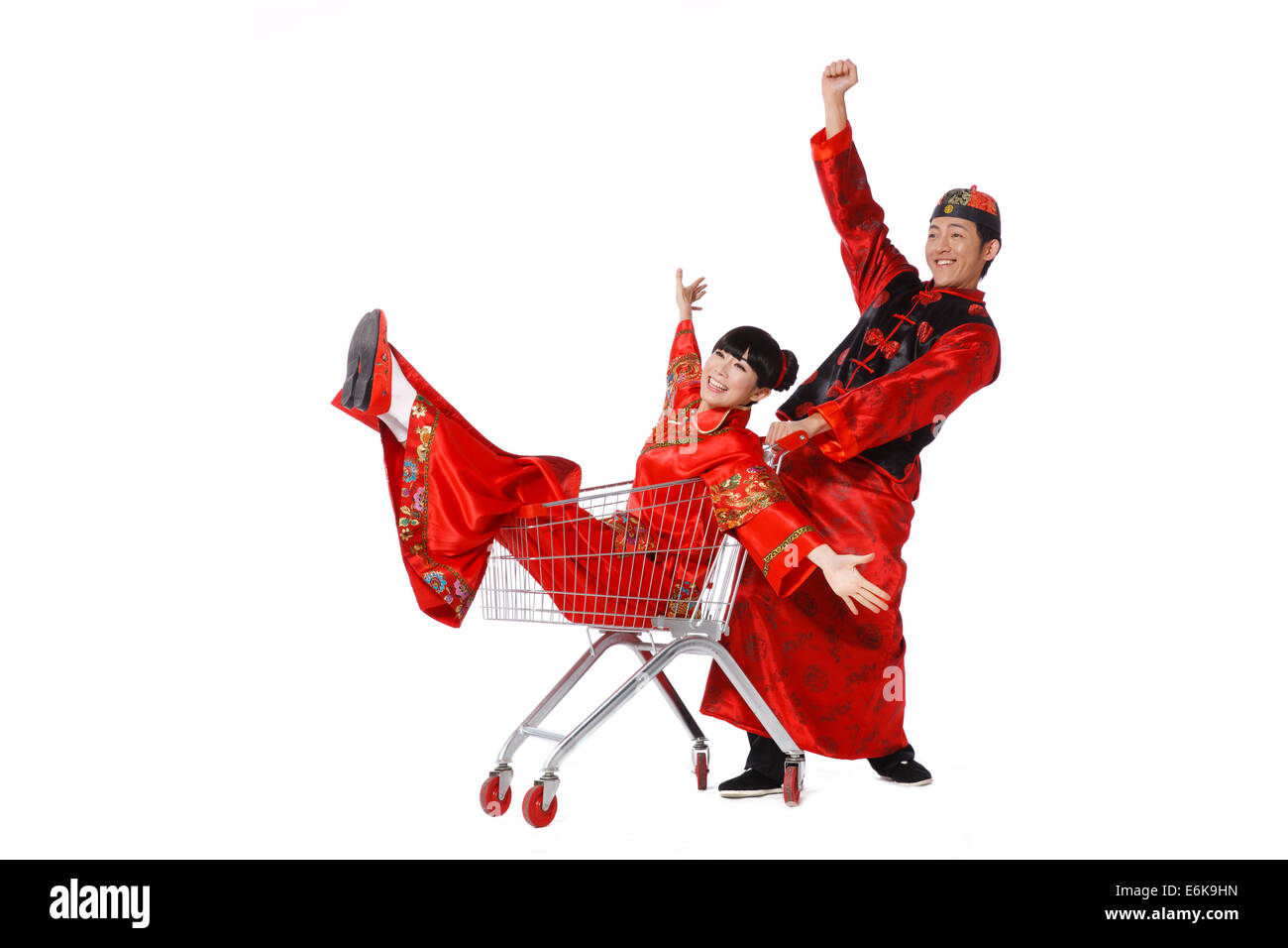 Young couple dressed in traditional clothes shopping with cart Stock ...