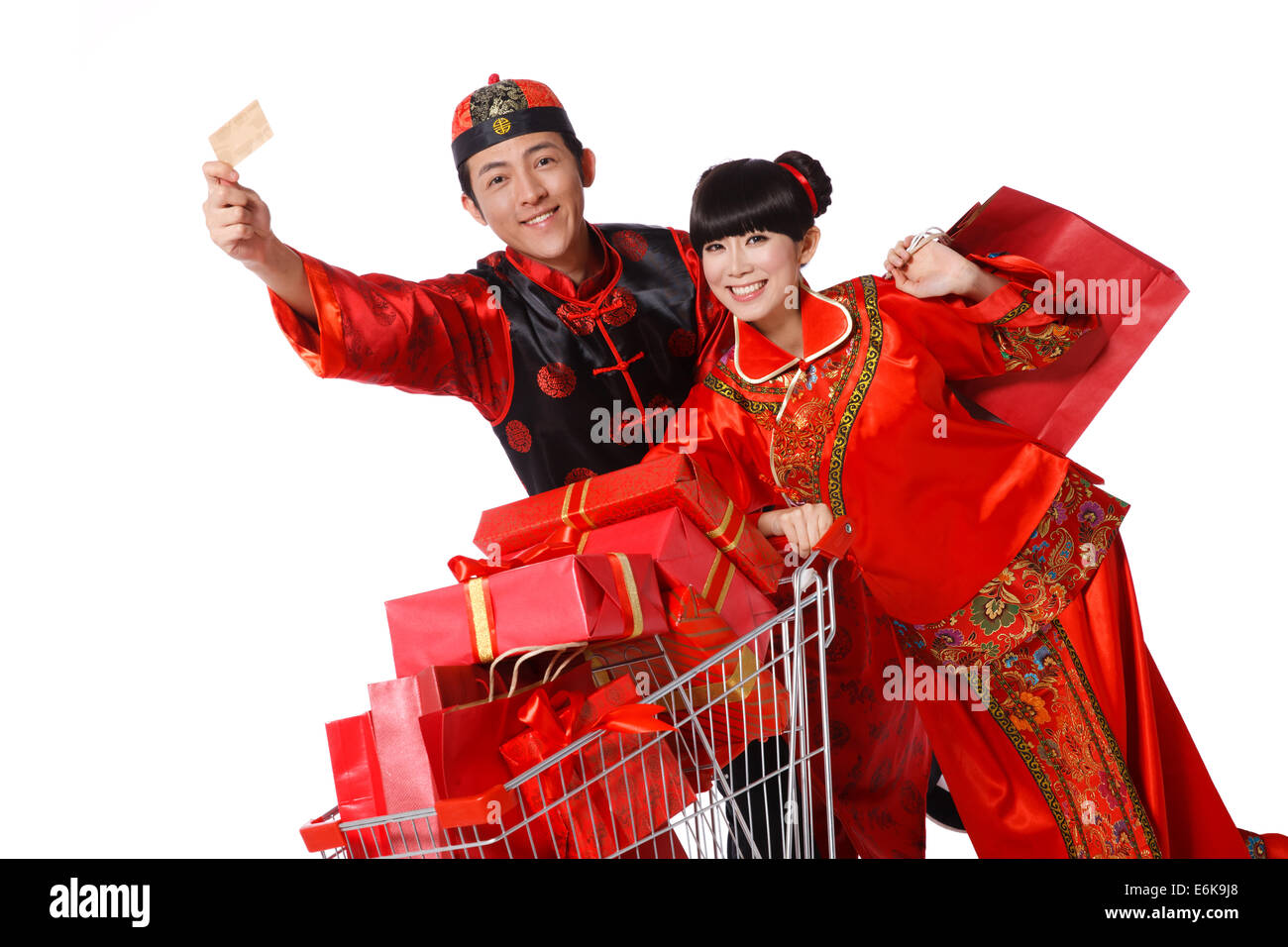 Young couple dressed in traditional clothes shopping with cart Stock ...