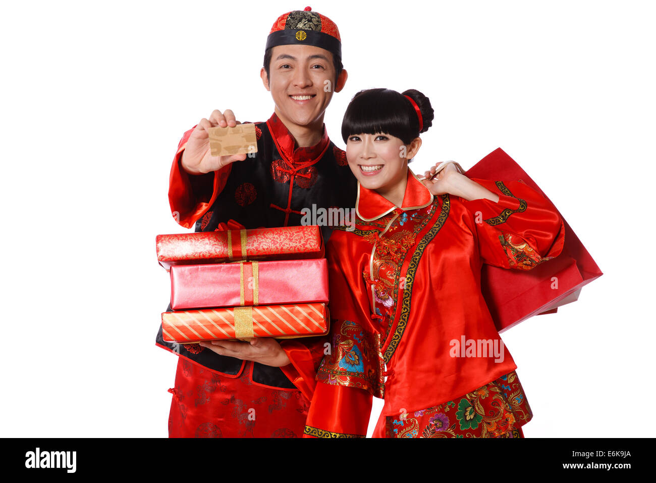 Young couple dressed in traditional clothes shopping with cart Stock ...
