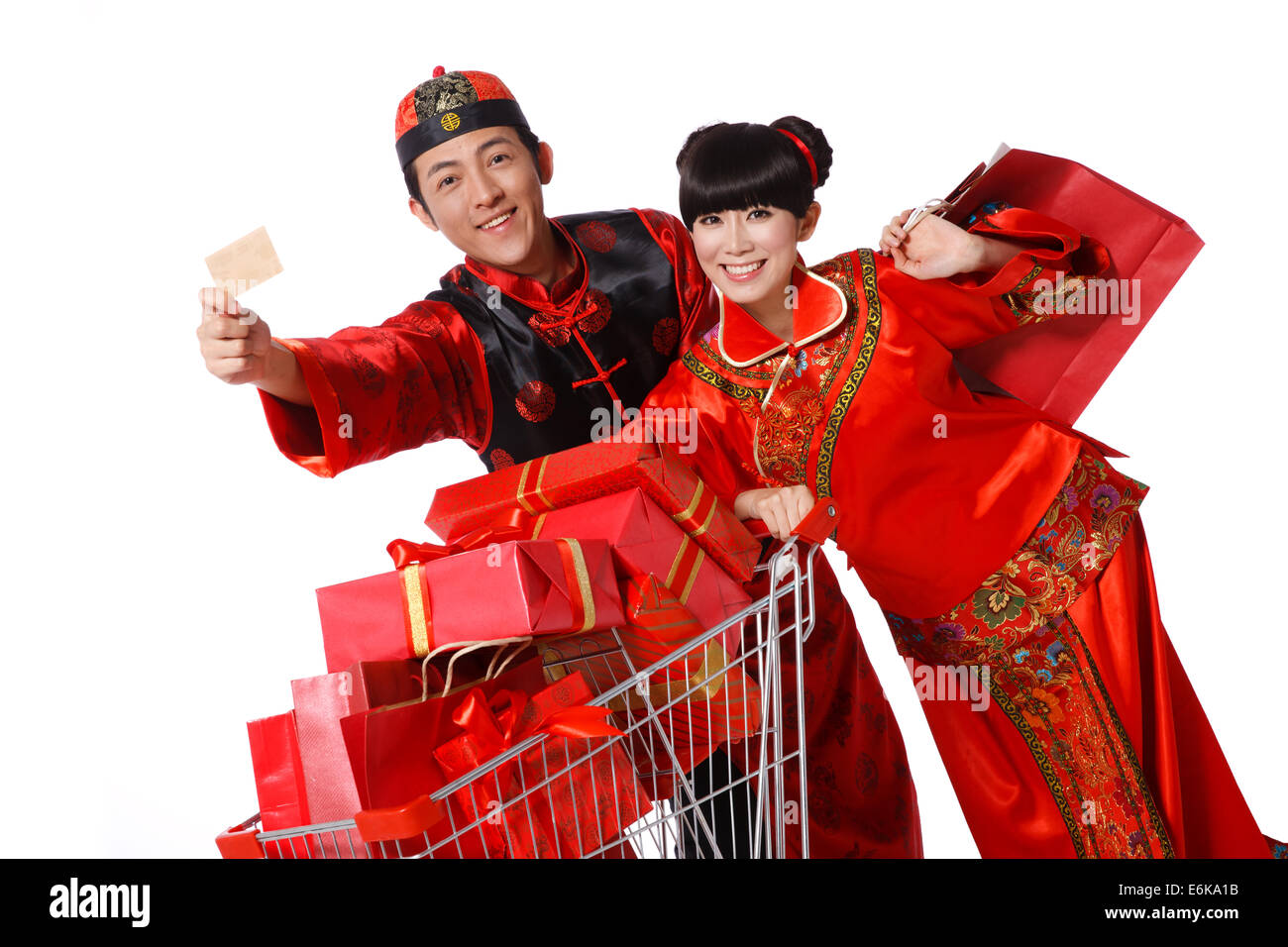 Young couple dressed in traditional clothes shopping with cart Stock ...