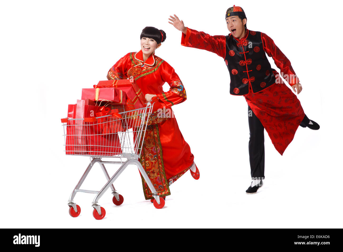 Young couple dressed in traditional clothes shopping with cart Stock ...