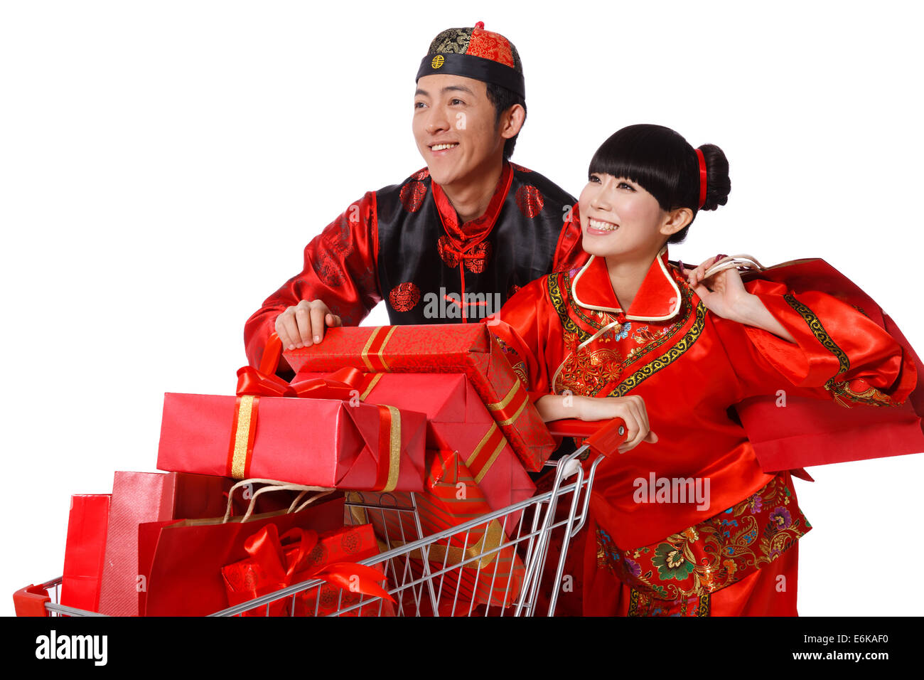Young couple dressed in traditional clothes shopping with cart Stock ...