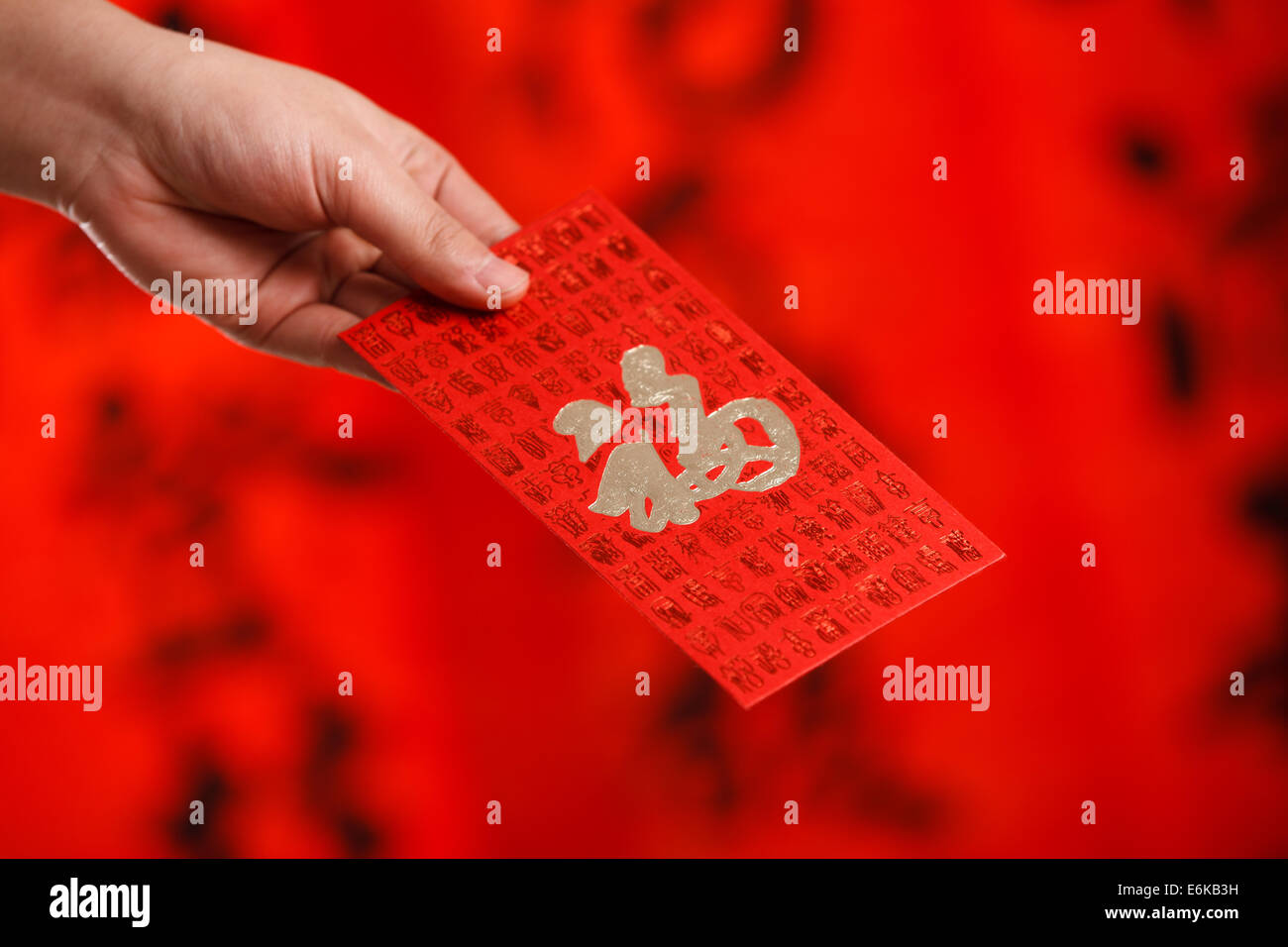 Hand holding red envelopes Stock Photo - Alamy
