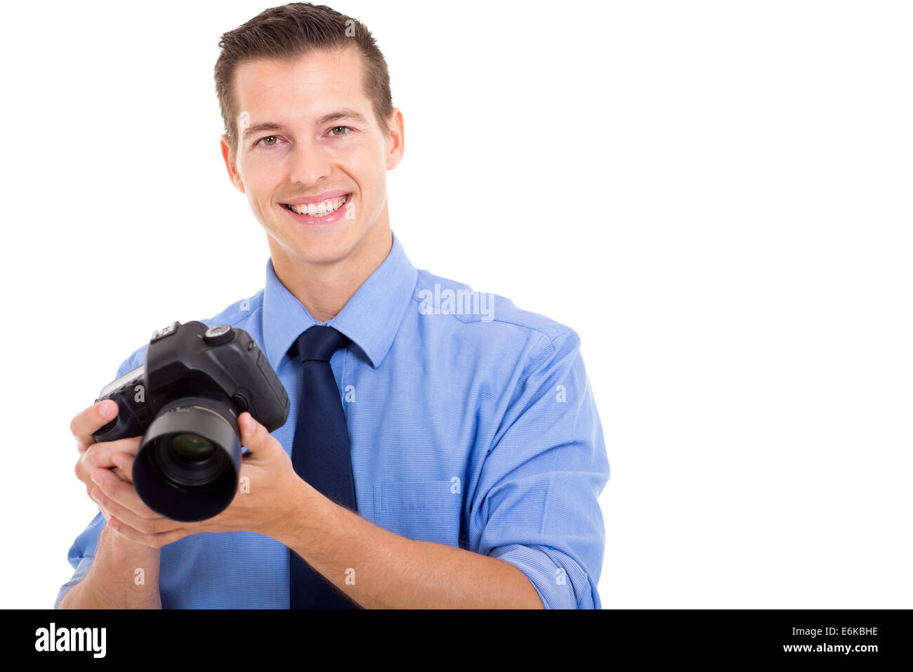 handsome young photographer holding a camera on white background Stock ...