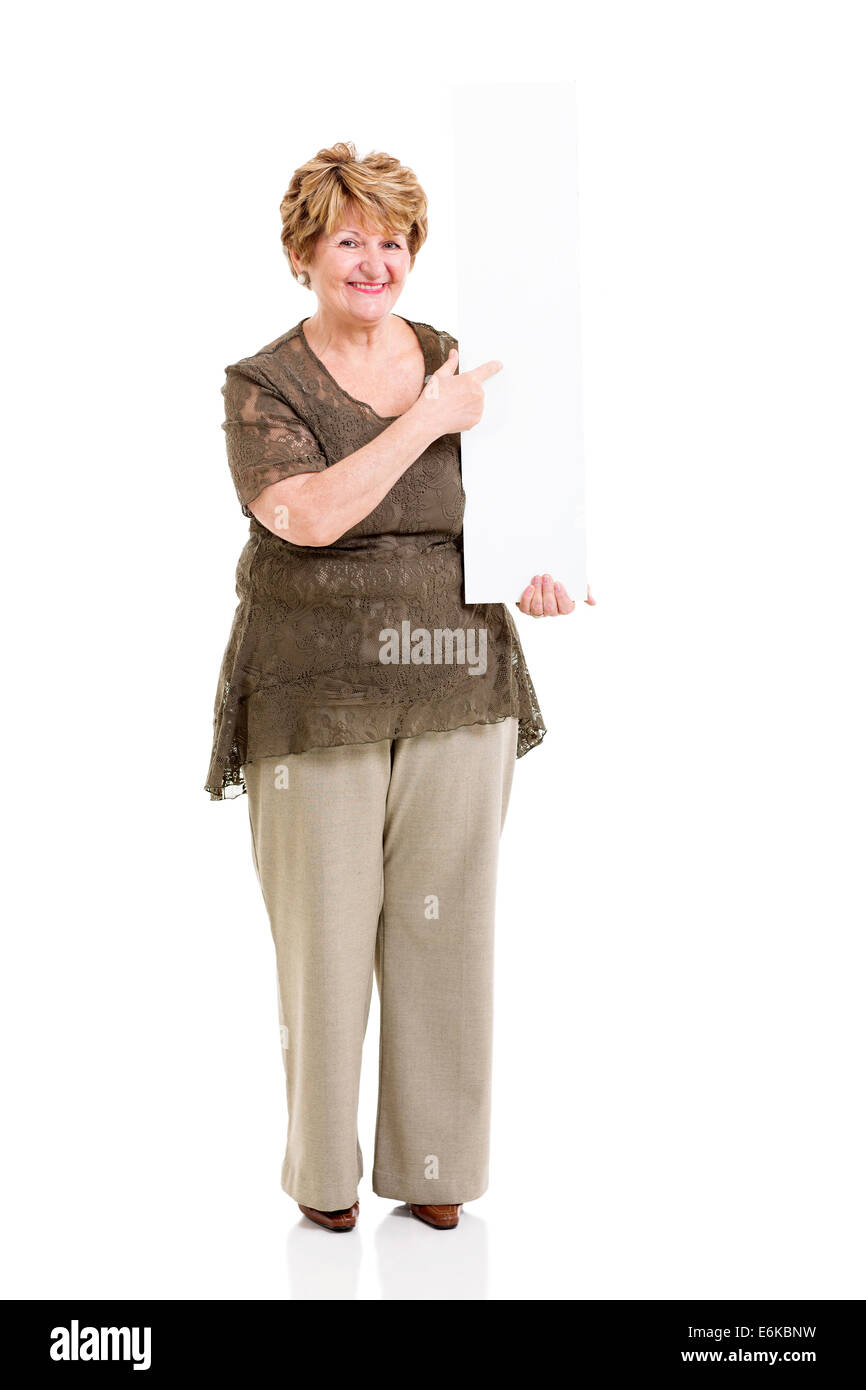 cheerful elderly woman pointing at empty white board isolated on white ...