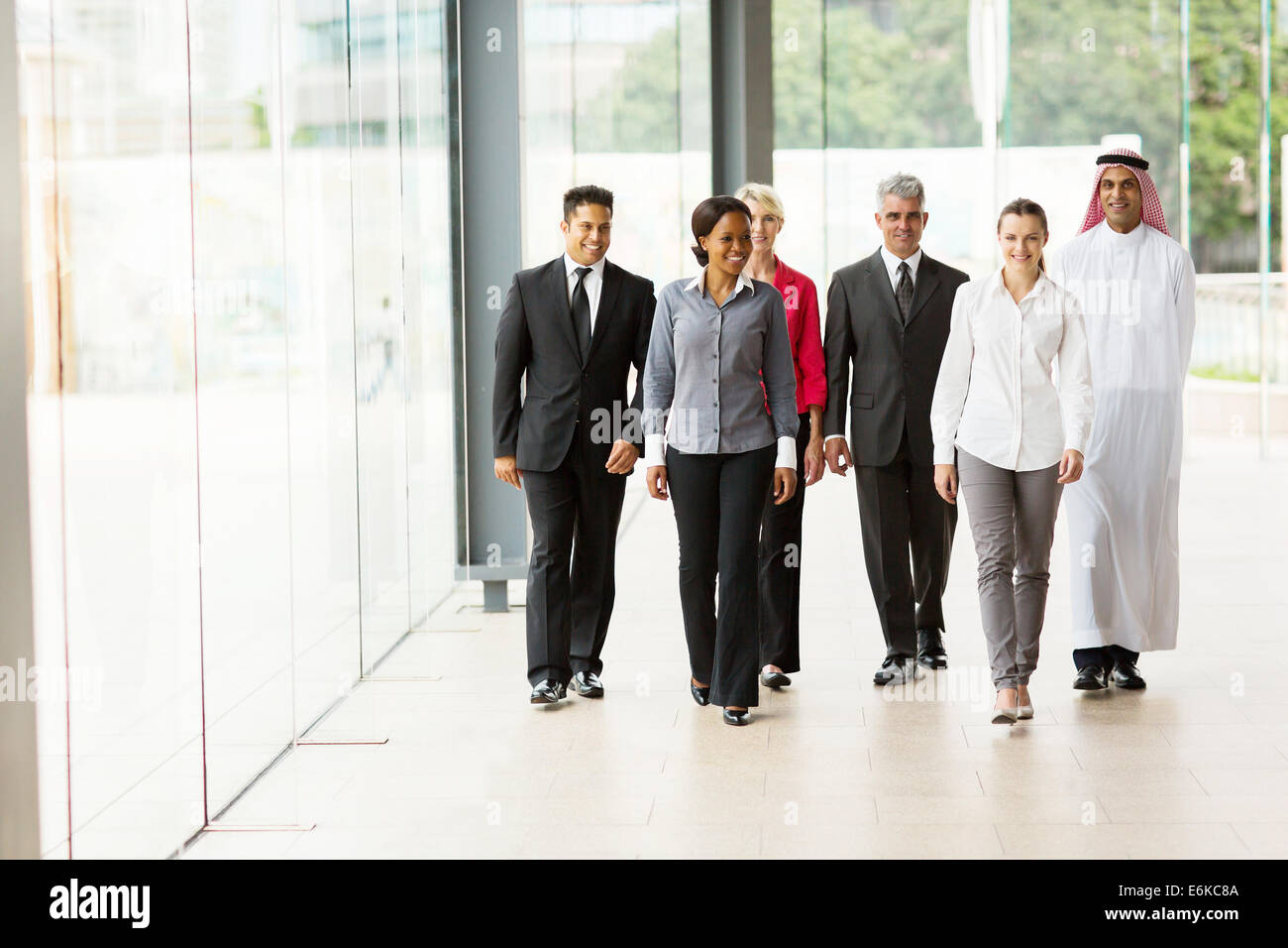 group of professional businesspeople walking in office building Stock ...