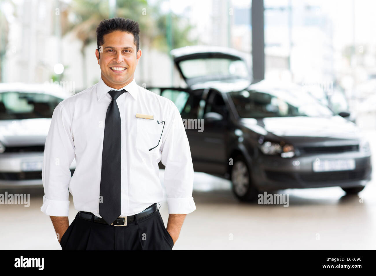 handsome Indian man working at vehicle showroom Stock Photo - Alamy