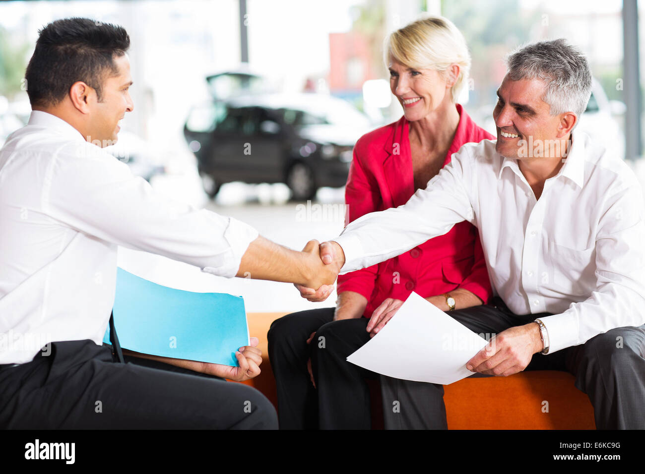 happy car salesman handshaking with senior buyer Stock Photo - Alamy