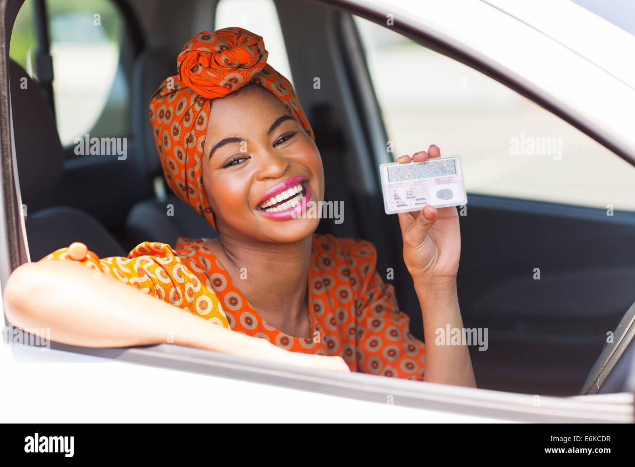 cheerful African woman showing a driving license she just got Stock ...