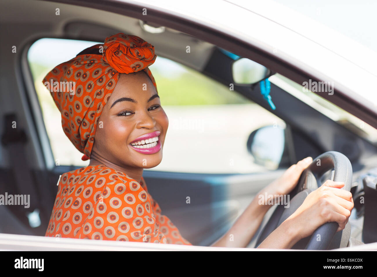 cheerful African female driver inside a car Stock Photo - Alamy