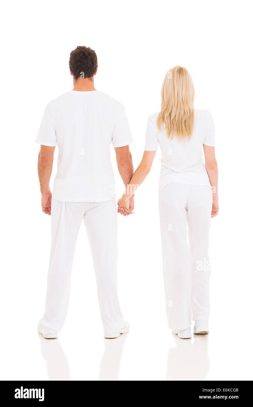 back view of young couple holding hands on white background Stock Photo ...