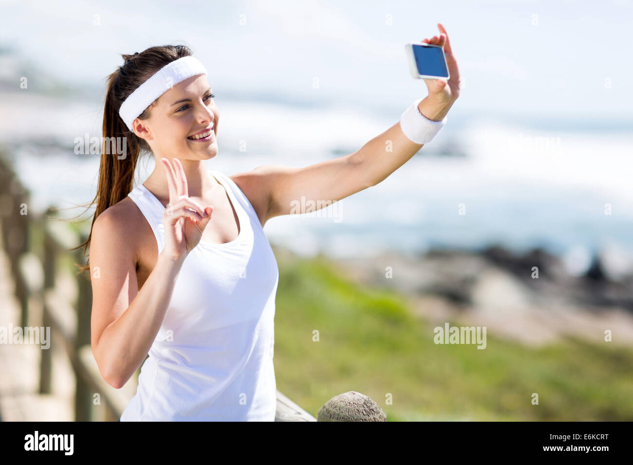 active young woman taking self portrait outdoors before exercise Stock ...