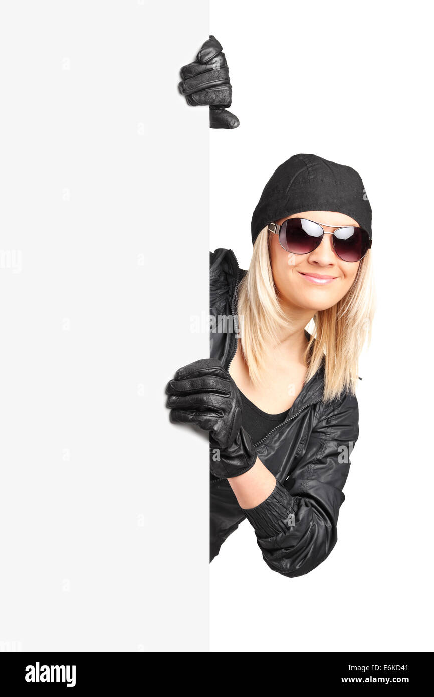 Cool woman posing behind blank panel isolated on white background Stock ...