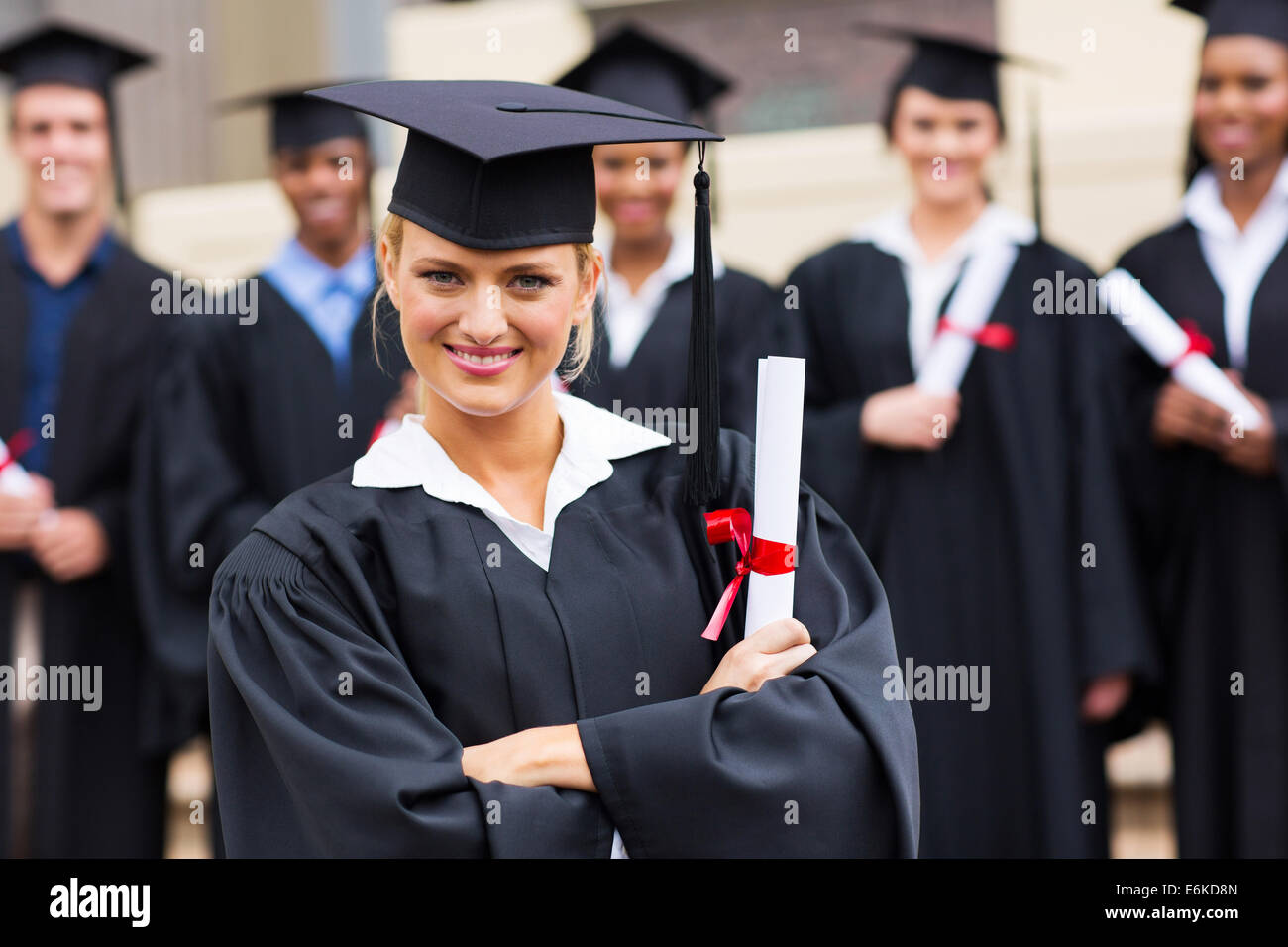 beautiful female college graduate with arms crossed at ceremony Stock ...
