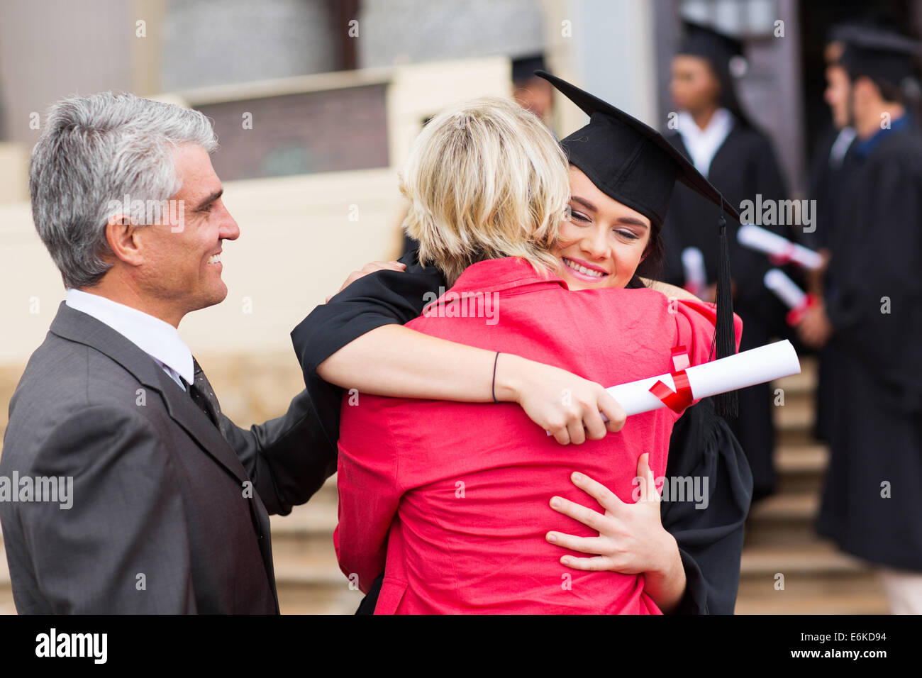 happy female graduate hugging her mother after graduation Stock Photo ...