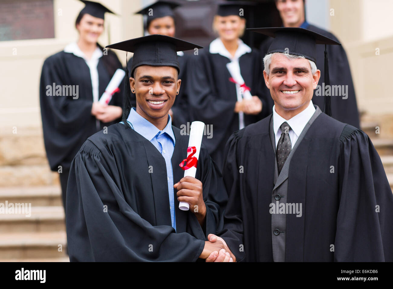 portrait of handsome African American male graduate with dean Stock ...