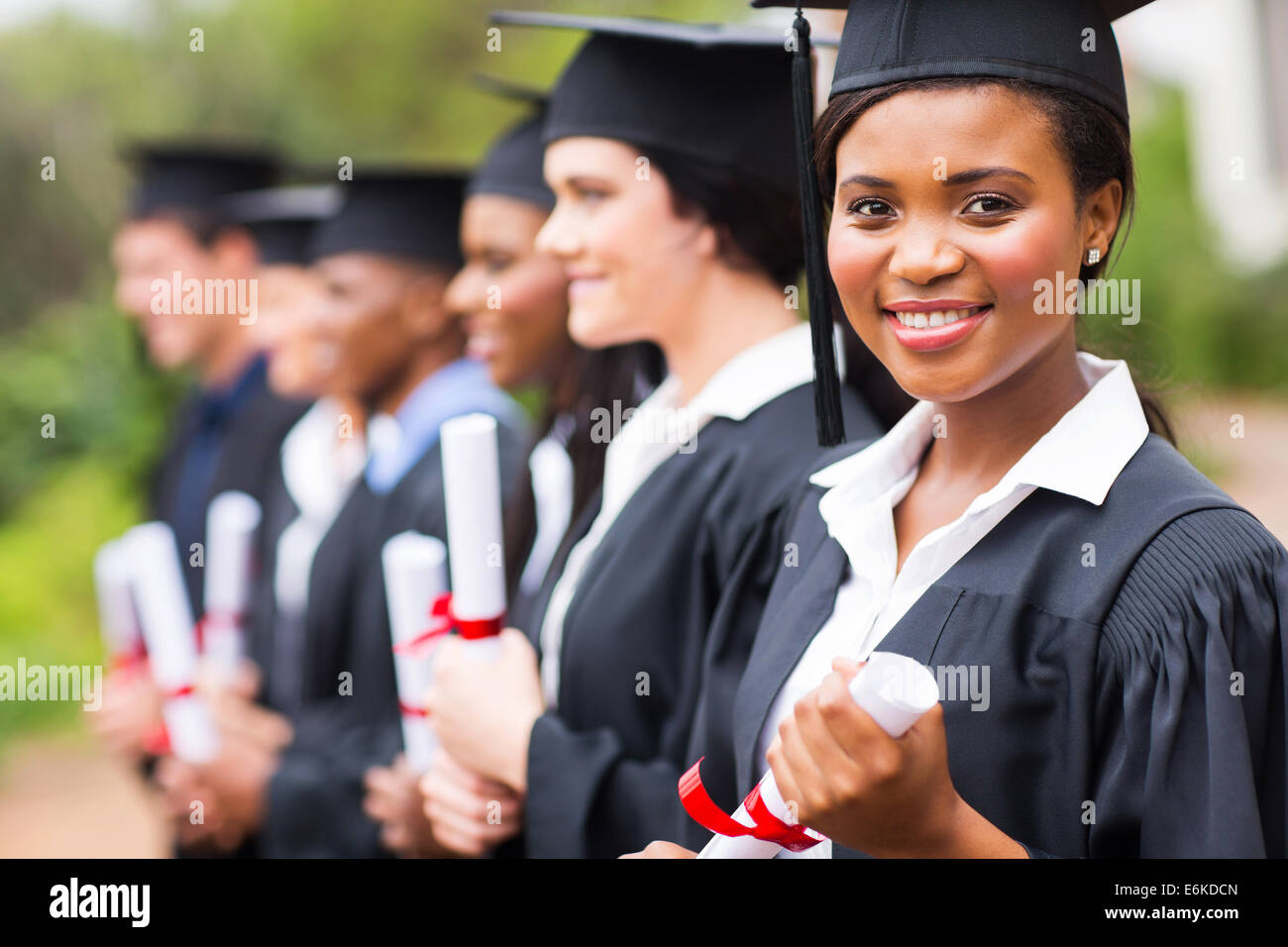 pretty African female college graduate at graduation with classmates ...