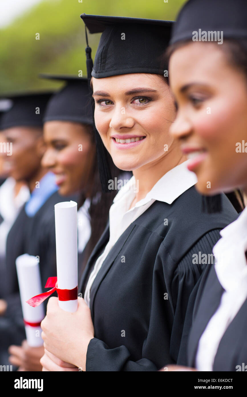 pretty young university graduate standing in a row Stock Photo - Alamy
