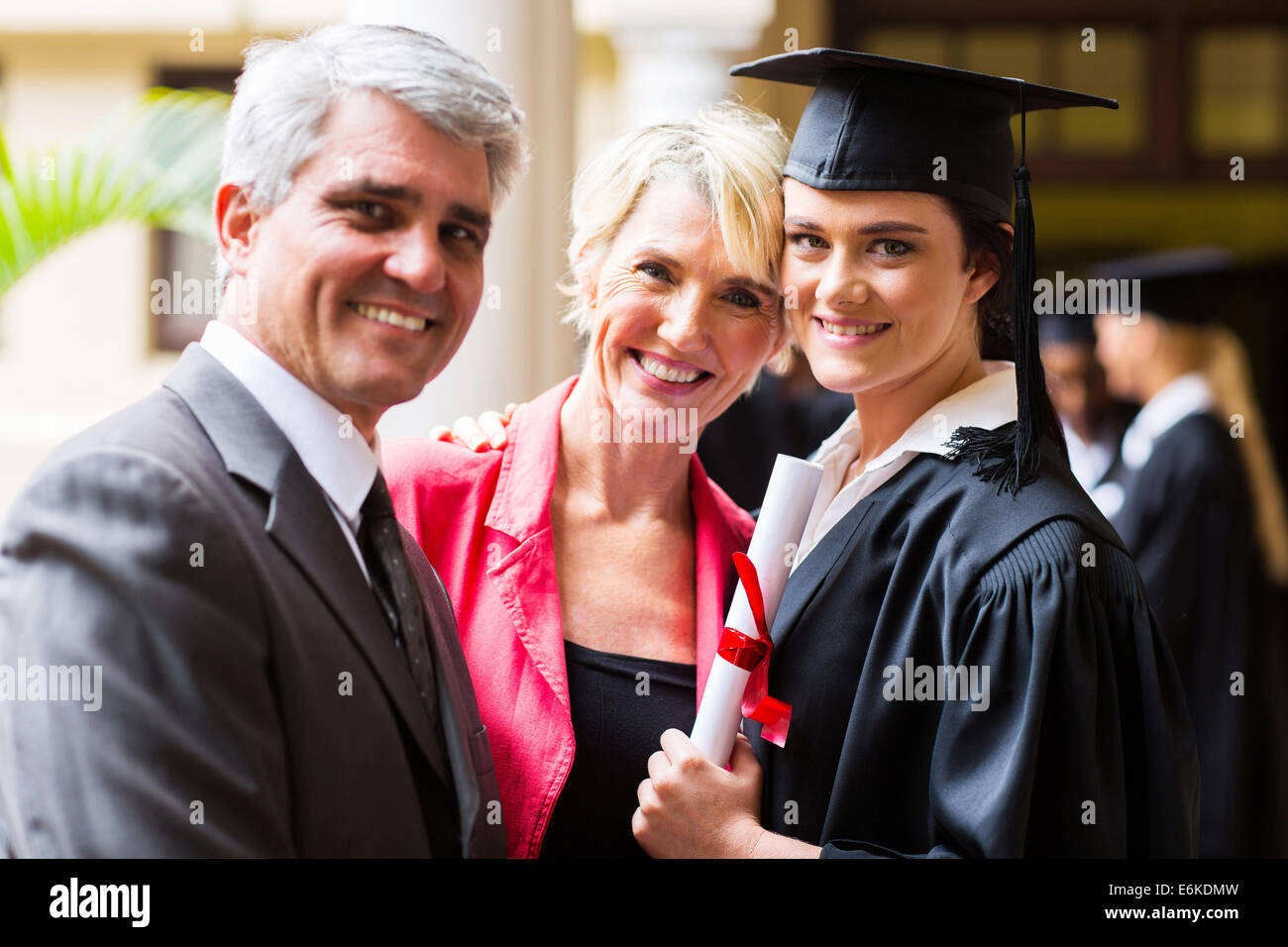 beautiful female college graduate with parents on graduation day Stock ...