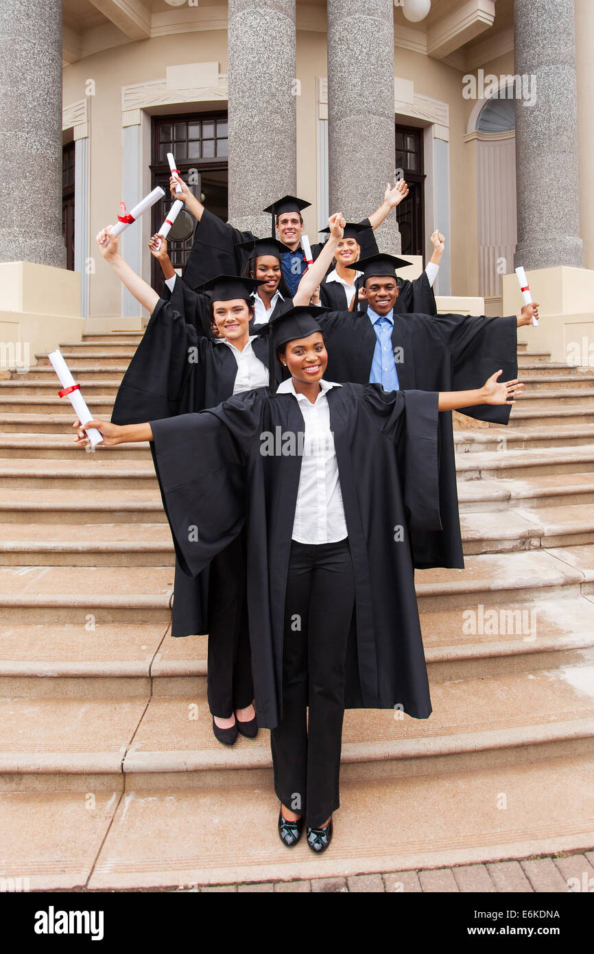 excited graduates standing outside college building Stock Photo - Alamy