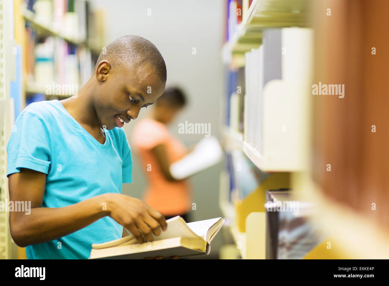 male African college student reading book in library Stock Photo - Alamy