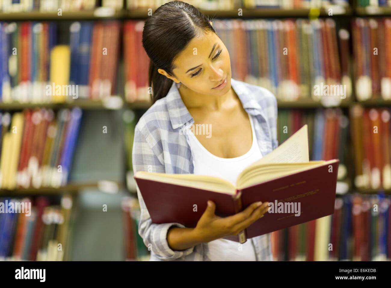 university student reading a book in library Stock Photo - Alamy